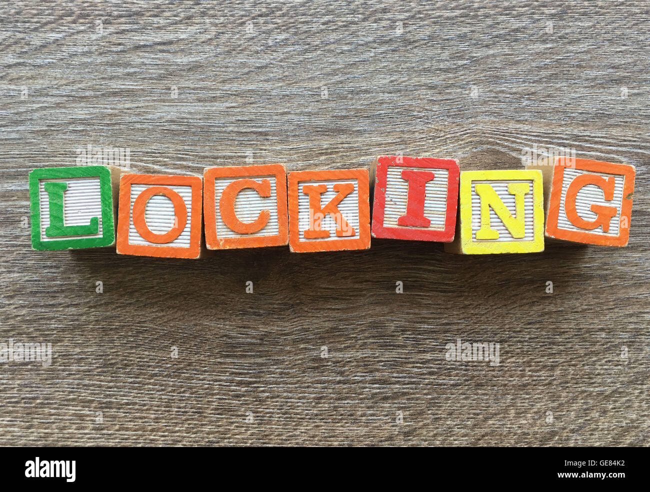 Wood blocks or wooden cubes toys with alphabet letters on them combined together to create the ...