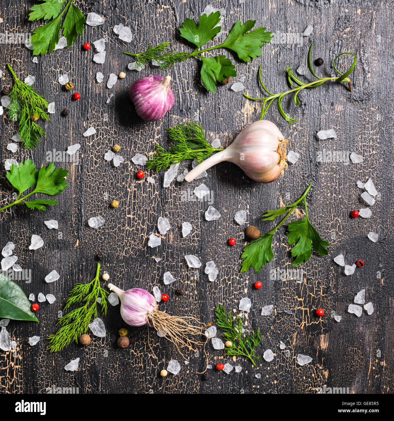 top view of setting garlic, dry peppers, sea salt, different greenery ...