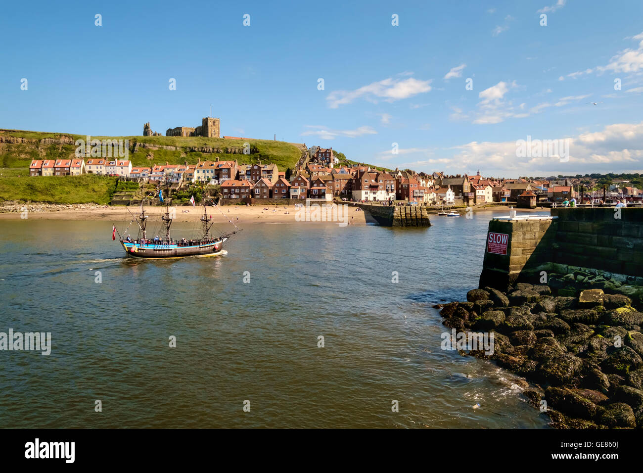 A pirate ship carrying tourists enters Whitby harbour, North Yorkshire ...