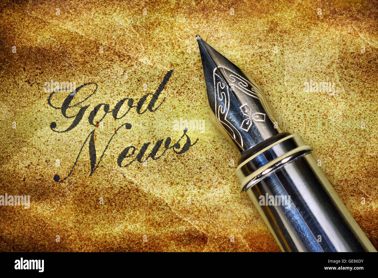 Closeup of a fountain pen and Text Good News written on grunge ...