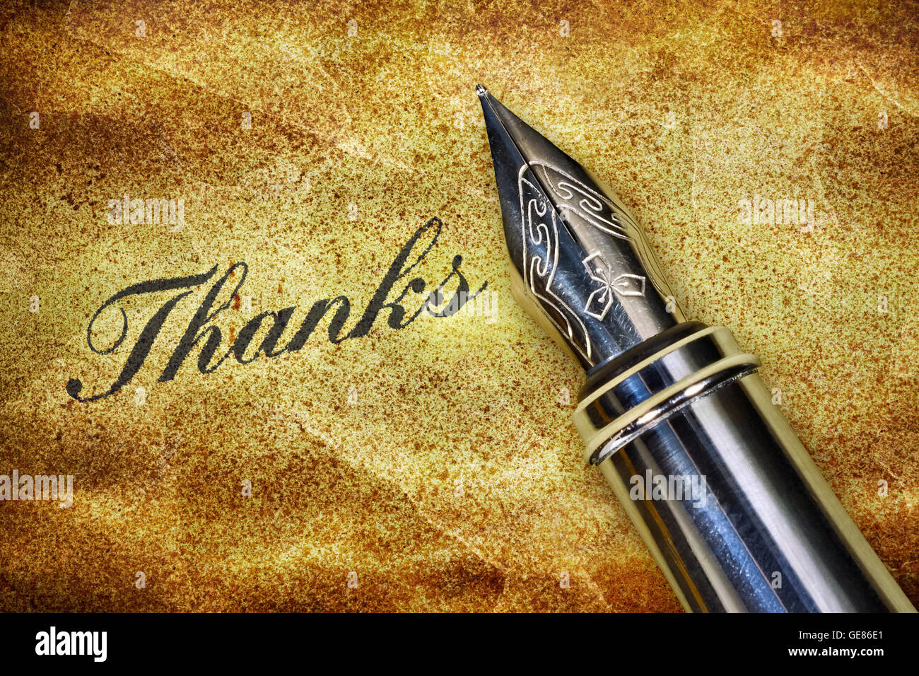 Closeup of a fountain pen and word Thanks written on grunge background ...