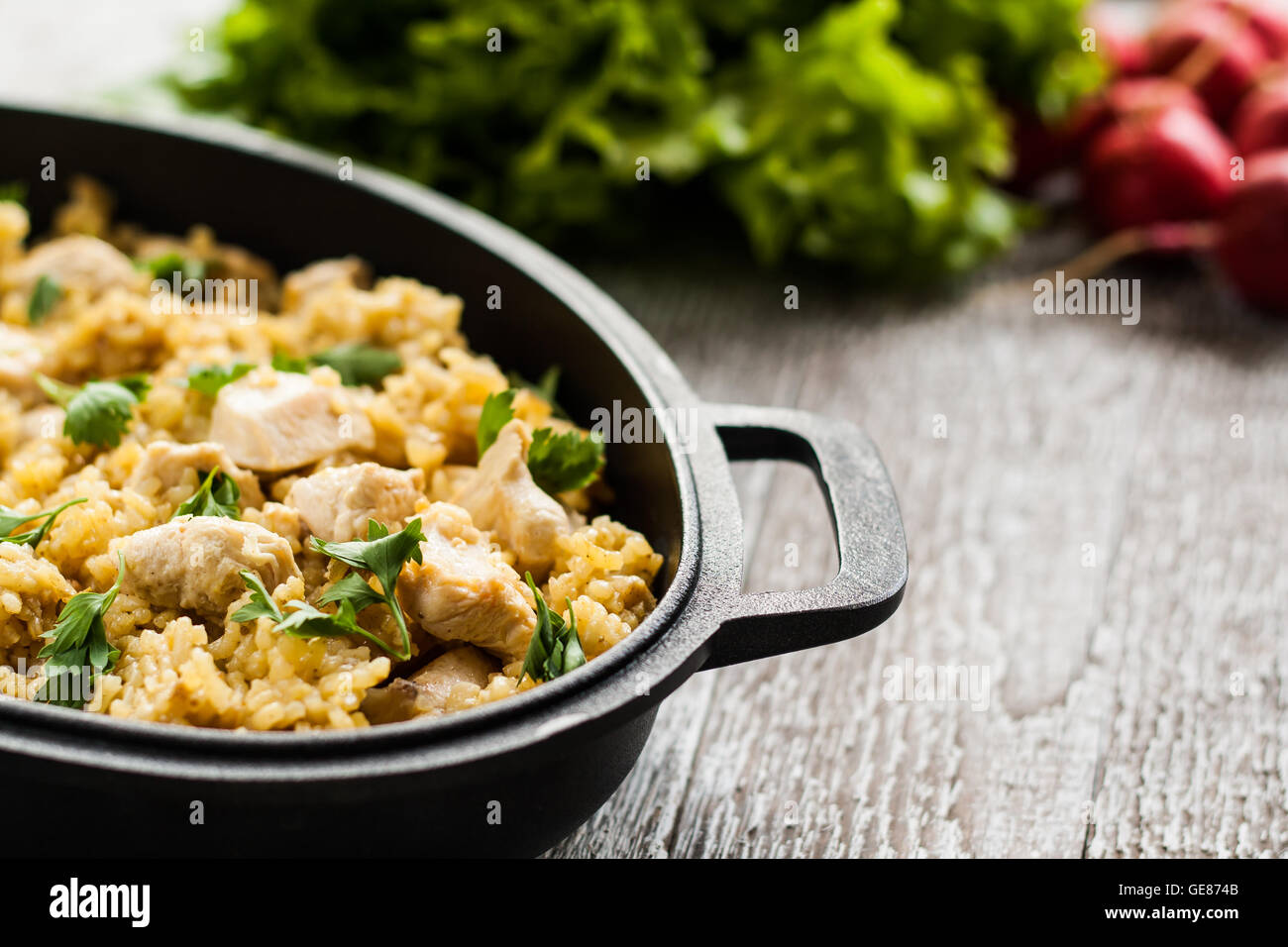 Pilaf rice-curry with chicken and salad in the form of iron Stock Photo ...