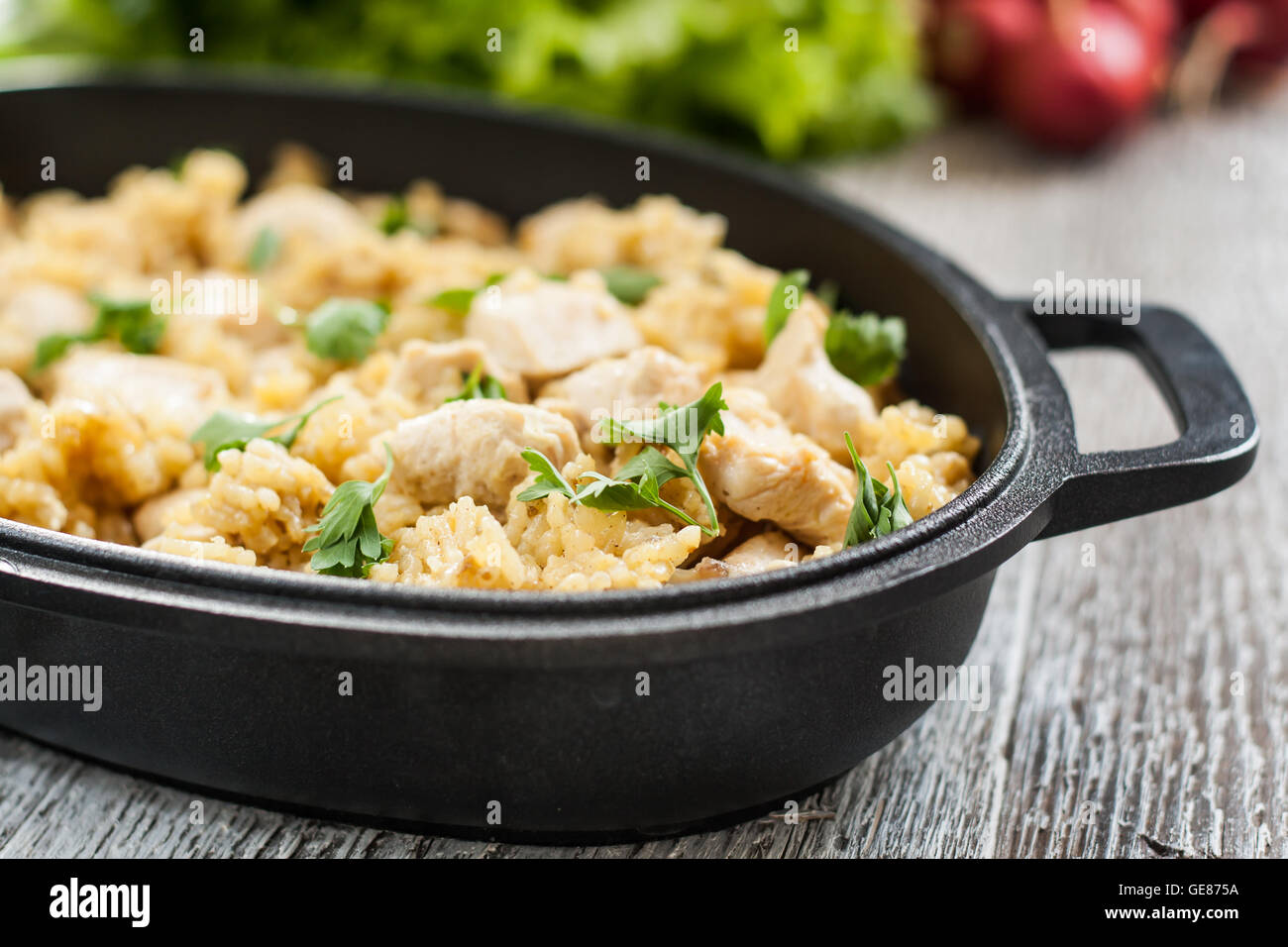 Pilaf rice-curry with chicken and salad in the form of iron Stock Photo ...