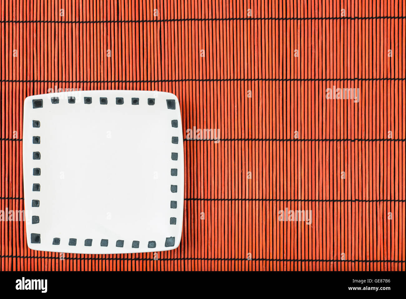 Plate on bamboo mat Stock Photo - Alamy