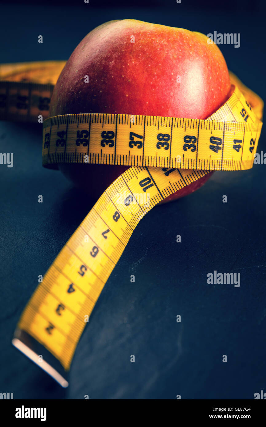apple with yellow measuring tape Stock Photo - Alamy