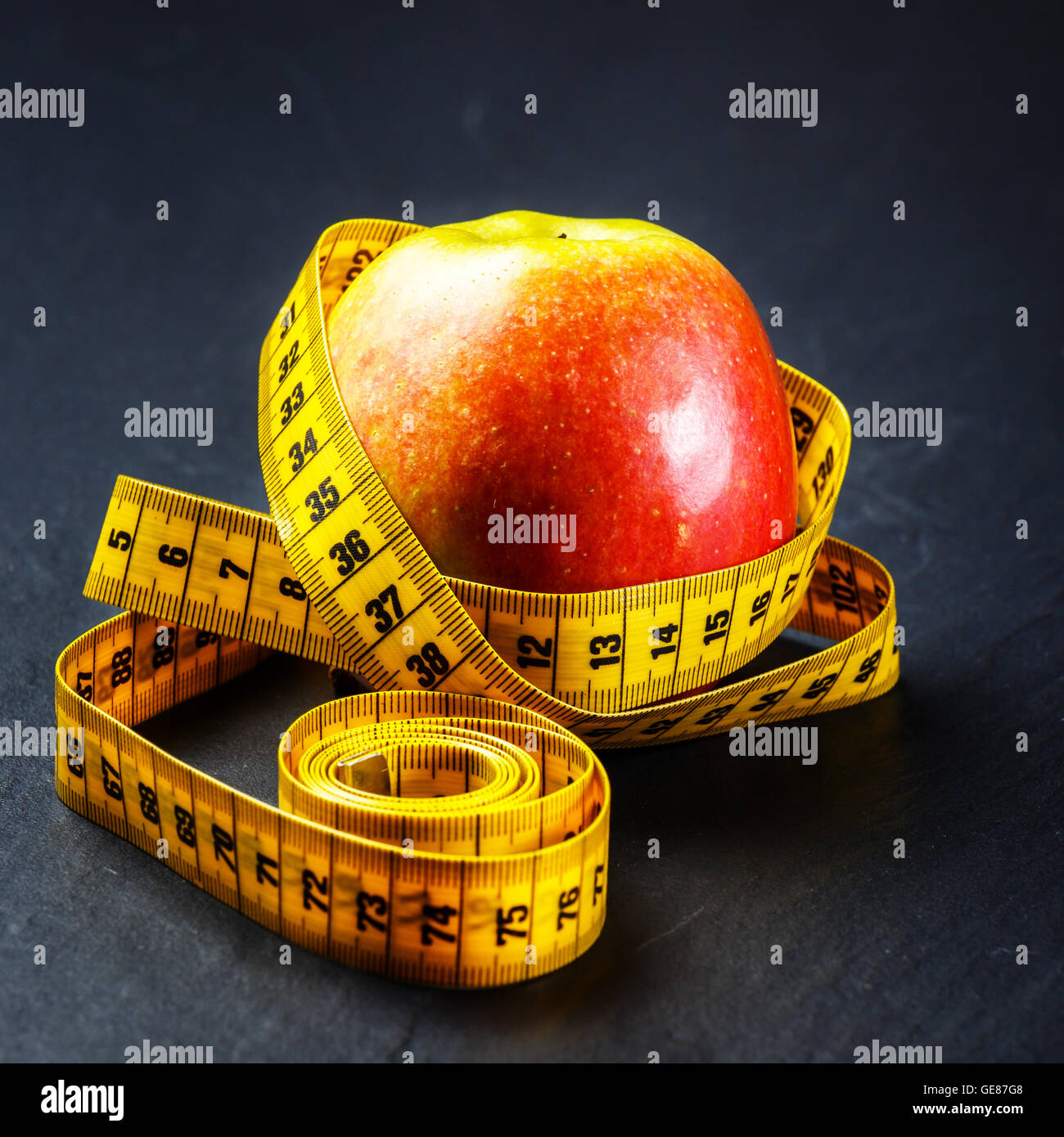 apple with yellow measuring tape Stock Photo - Alamy
