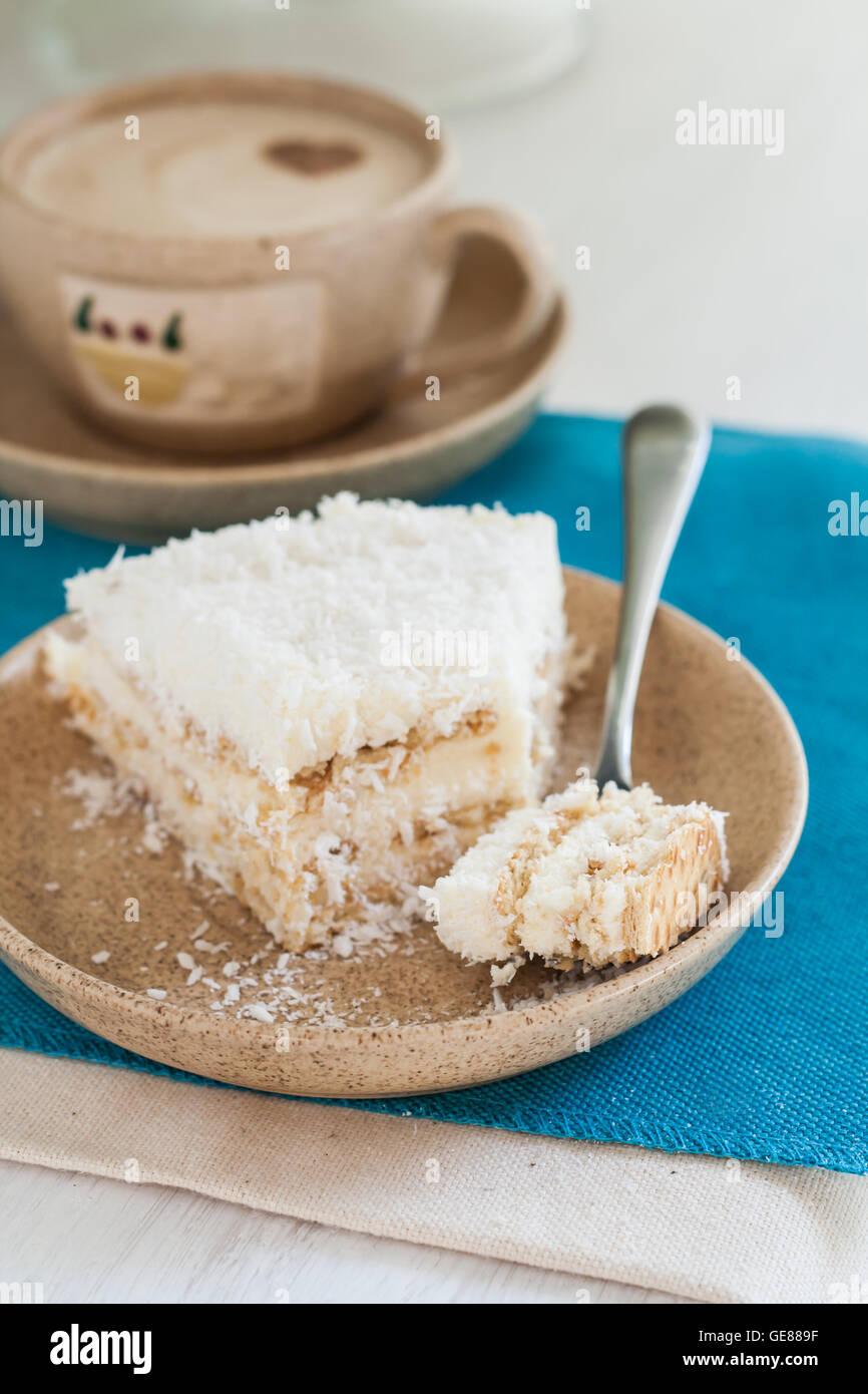On a piece of coconut cake plate Stock Photo - Alamy