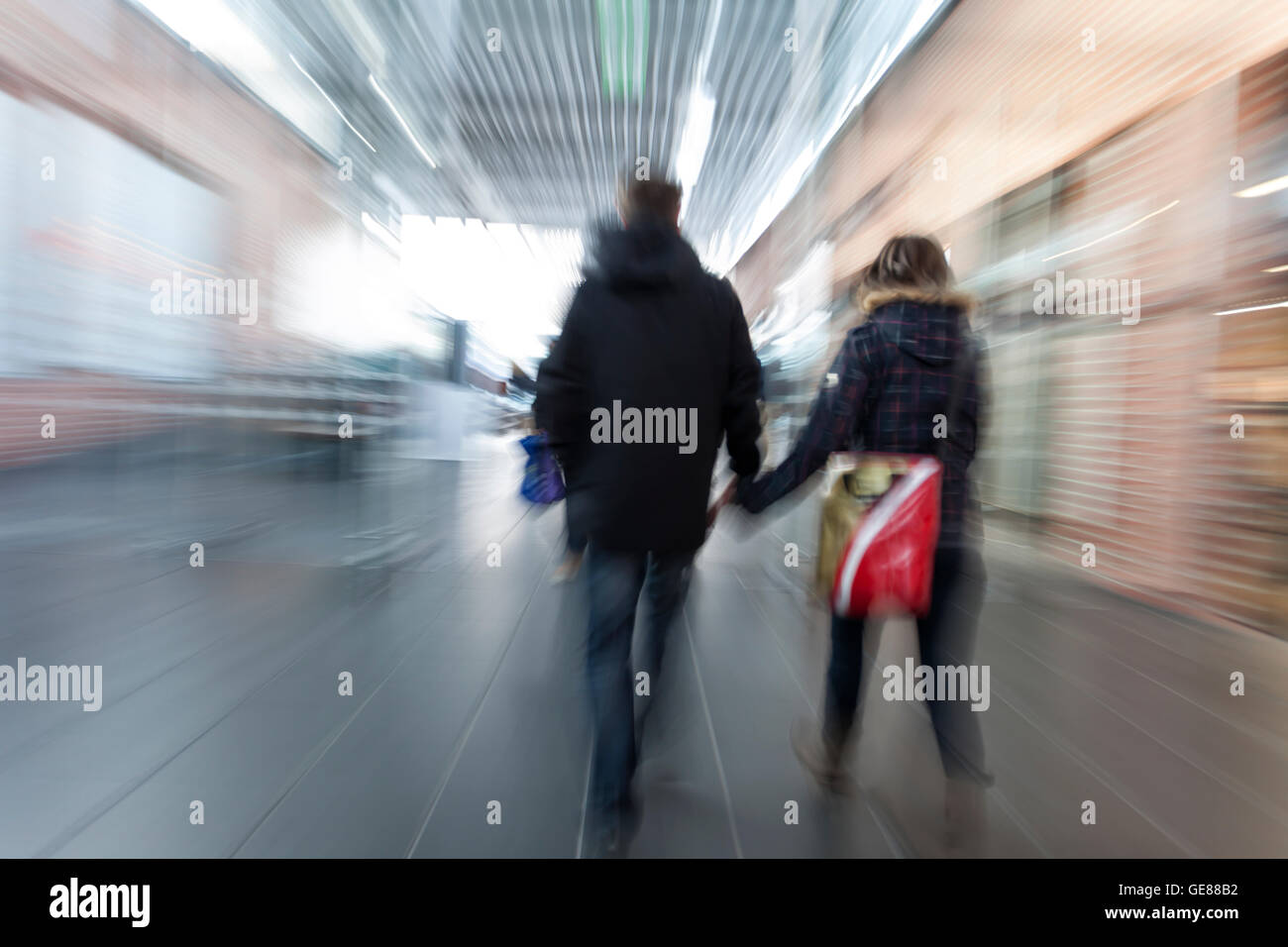 Shopper walking against shop window Stock Photo - Alamy