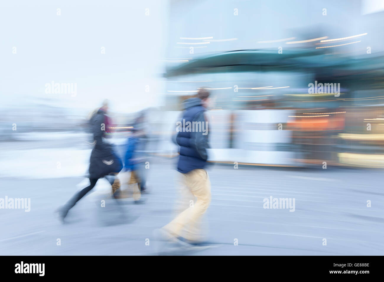 Shopper walking against shop window Stock Photo - Alamy