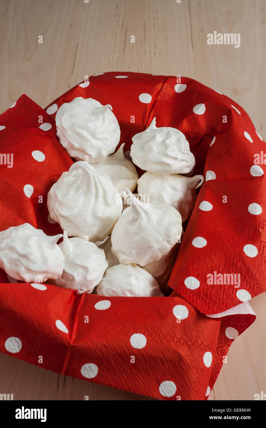 Small meringues meringue on a red background Stock Photo - Alamy