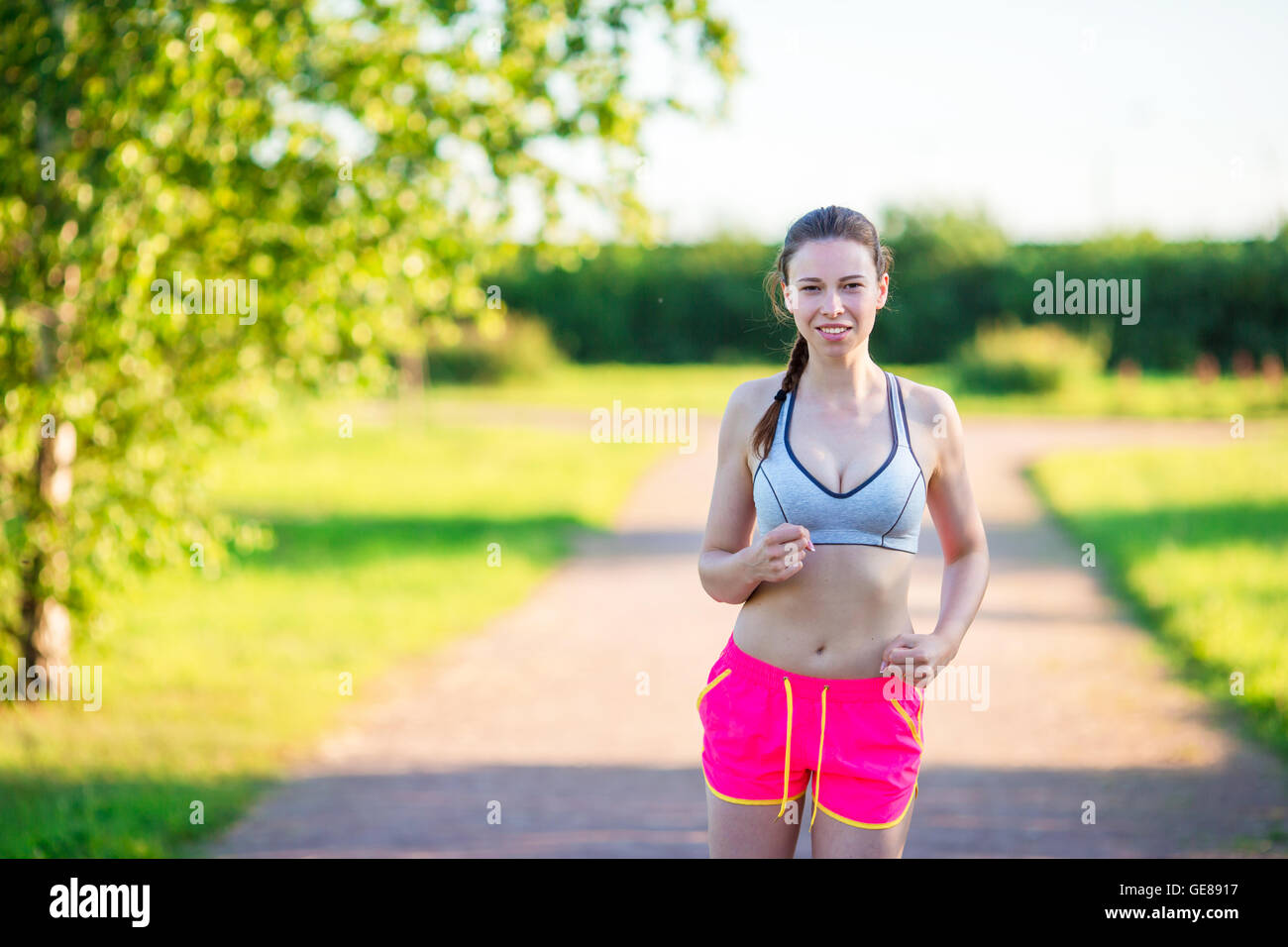 Beautiful young sport girl running outdoors. Runner - woman running ...