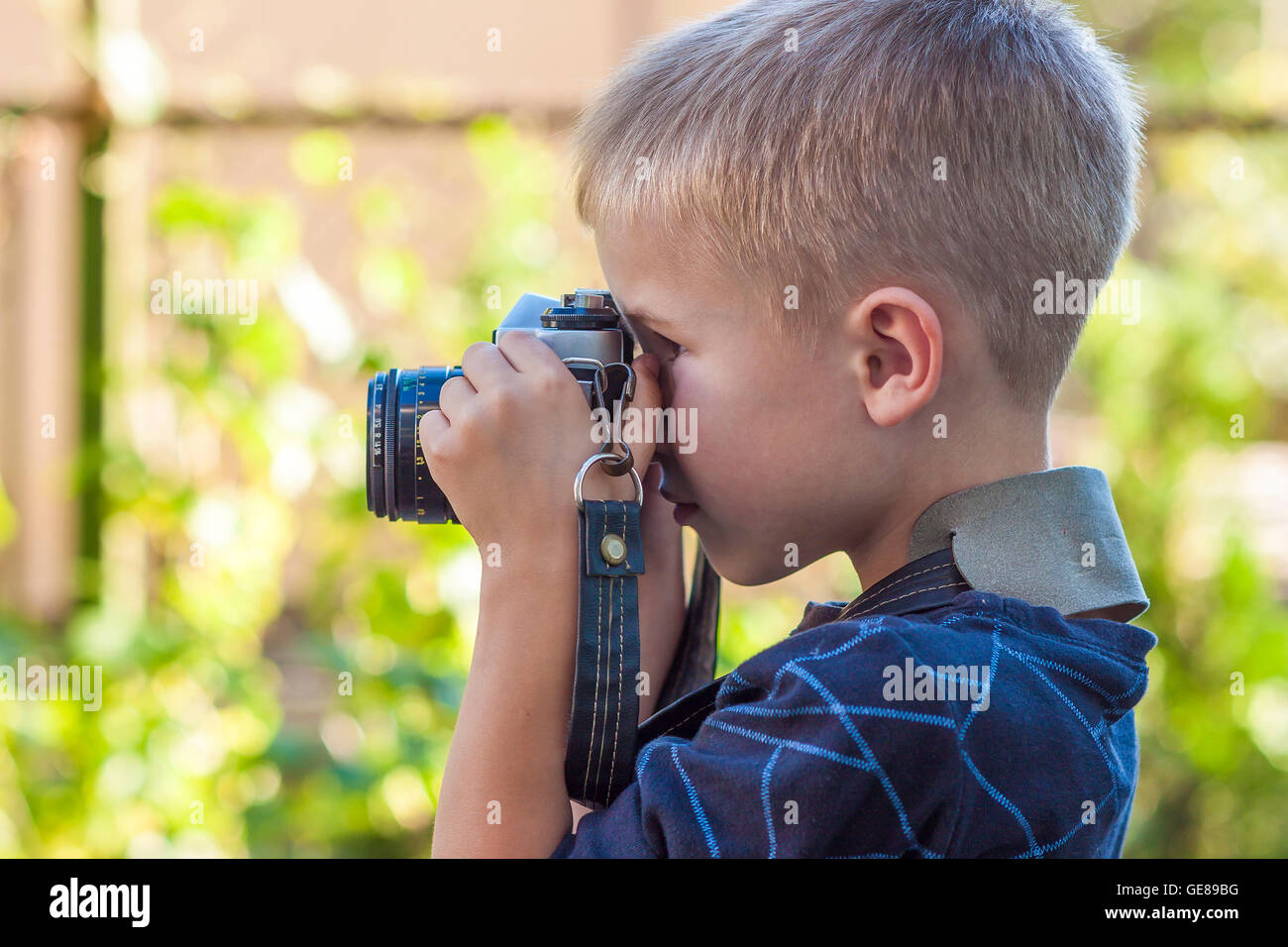 Cute little happy boy with vintage photo camera outdoors Stock Photo ...