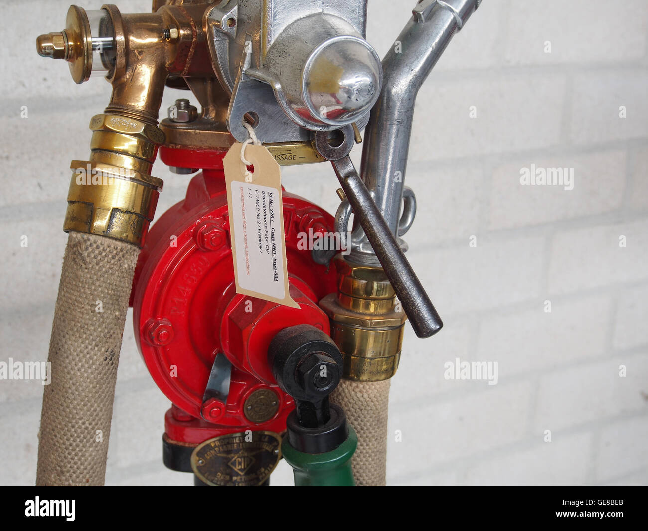This image features a benzine pump, commonly used in the 20th century ...