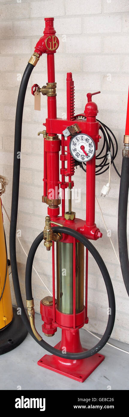 This image shows a vintage gasoline pump, also known as a benzine pump ...