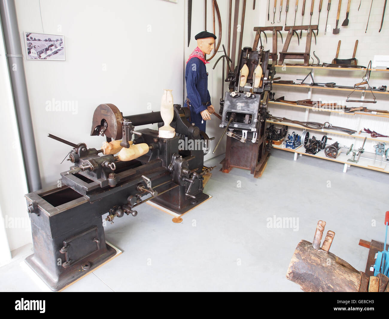This image captures the traditional process of wooden clog-making, a ...