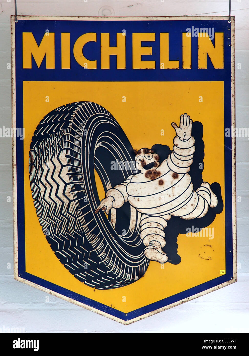 An enamel advertisement sign for Michelin, featuring the iconic ...