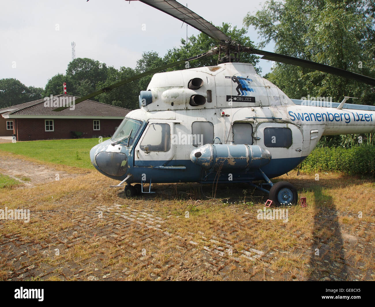 The Mil Mi-2 helicopter, featuring advertising for Swanenberg IJzer ...