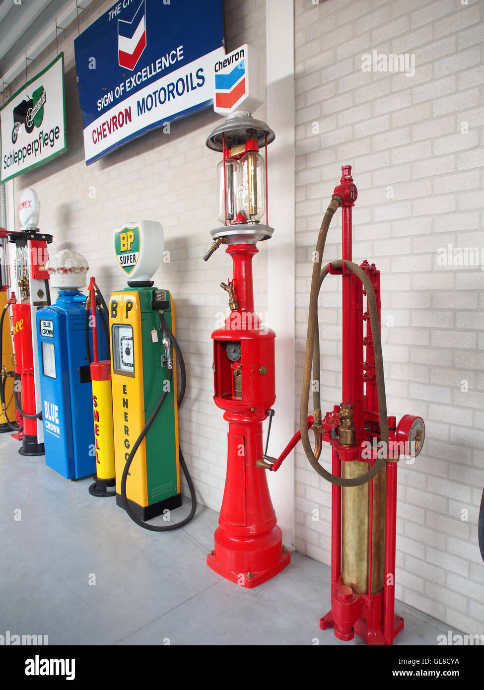 This image depicts a collection of vintage gas pumps on display at a ...