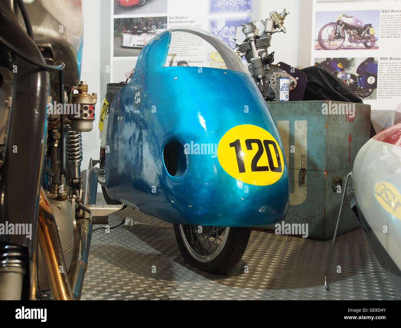 The image features an NSU racing motorcycle, model No. 120, a notable ...