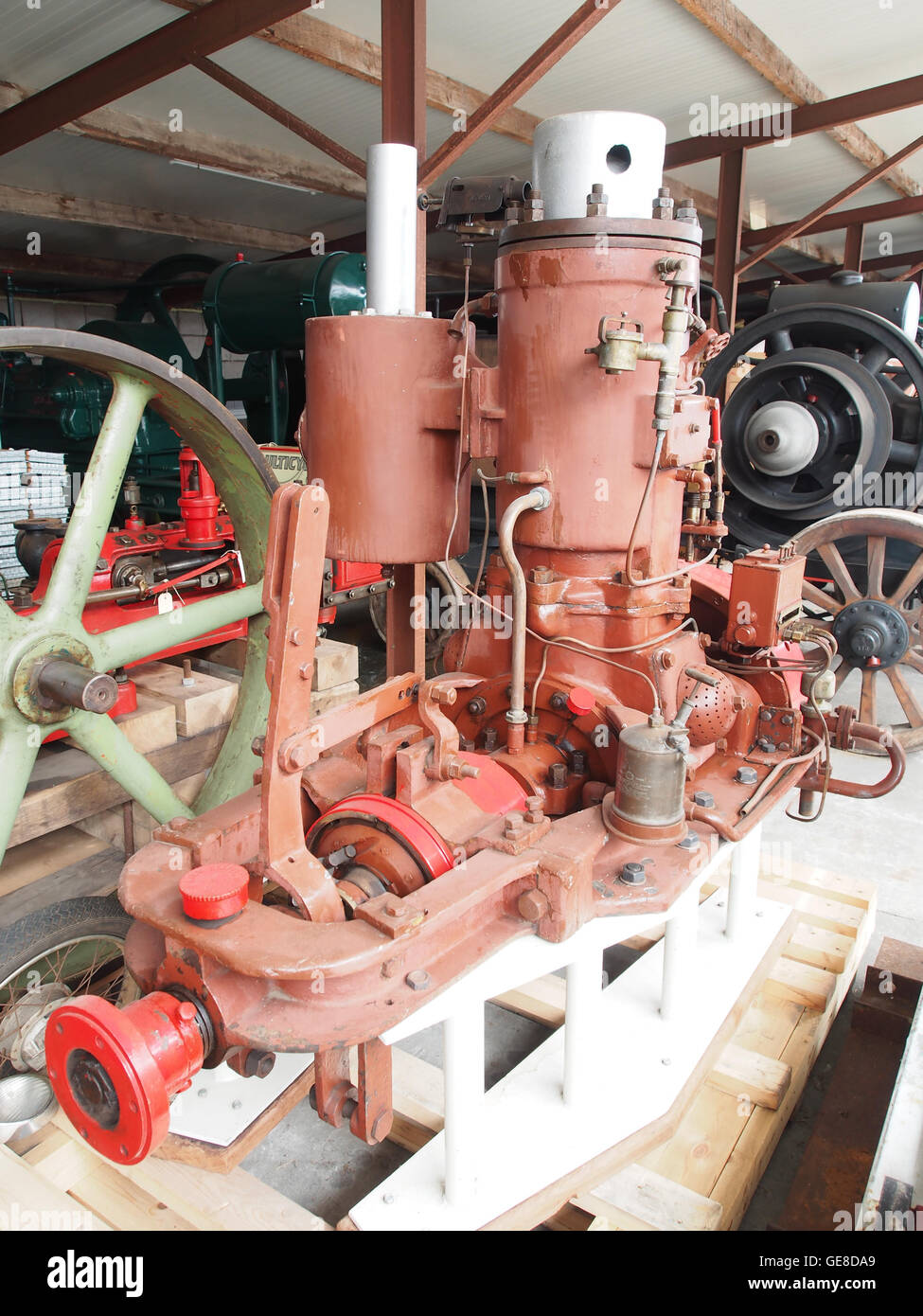 This image features an antique stationary engine displayed in the ...