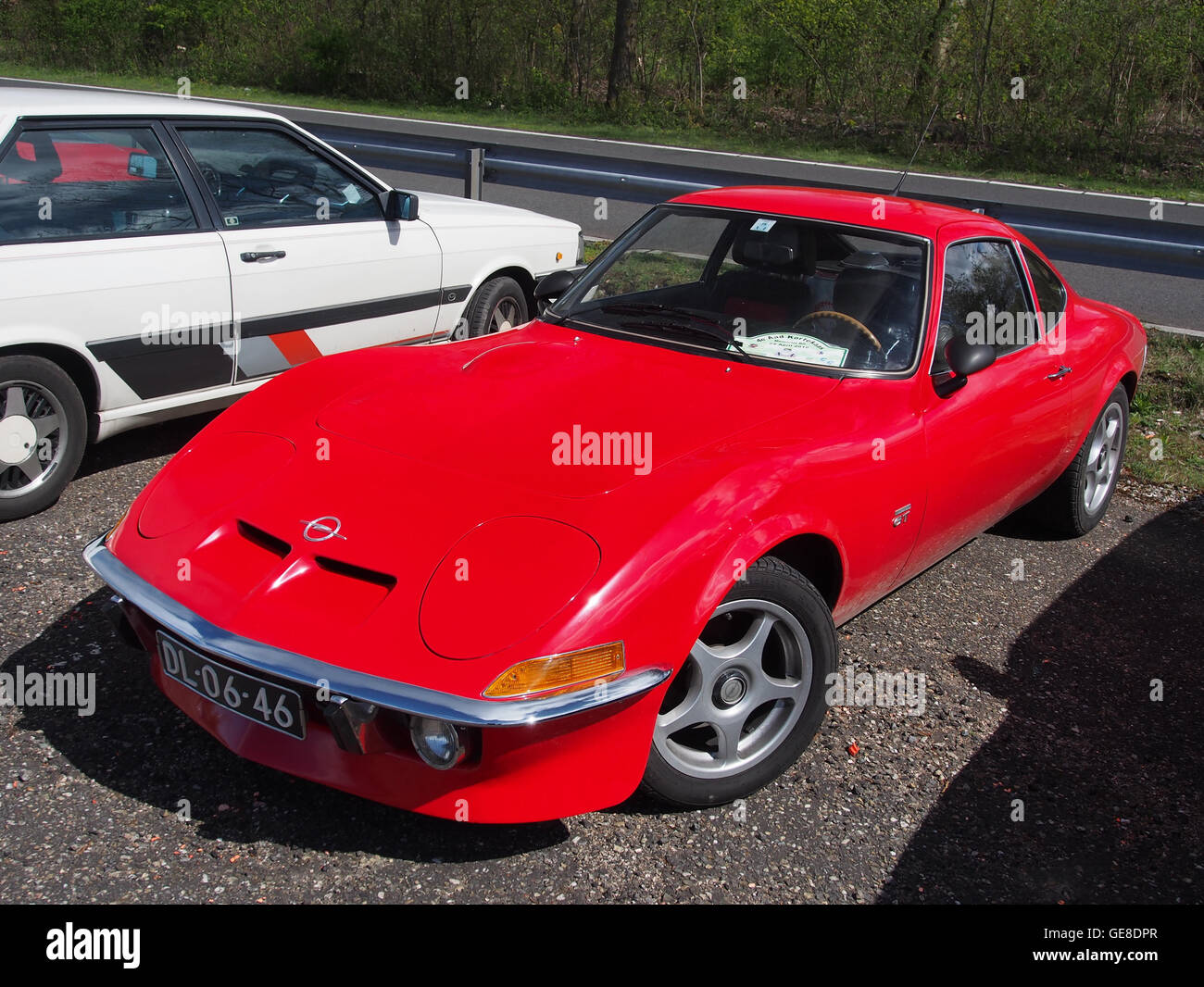 This image features a 1970 Opel GT, a classic sports car known for its ...