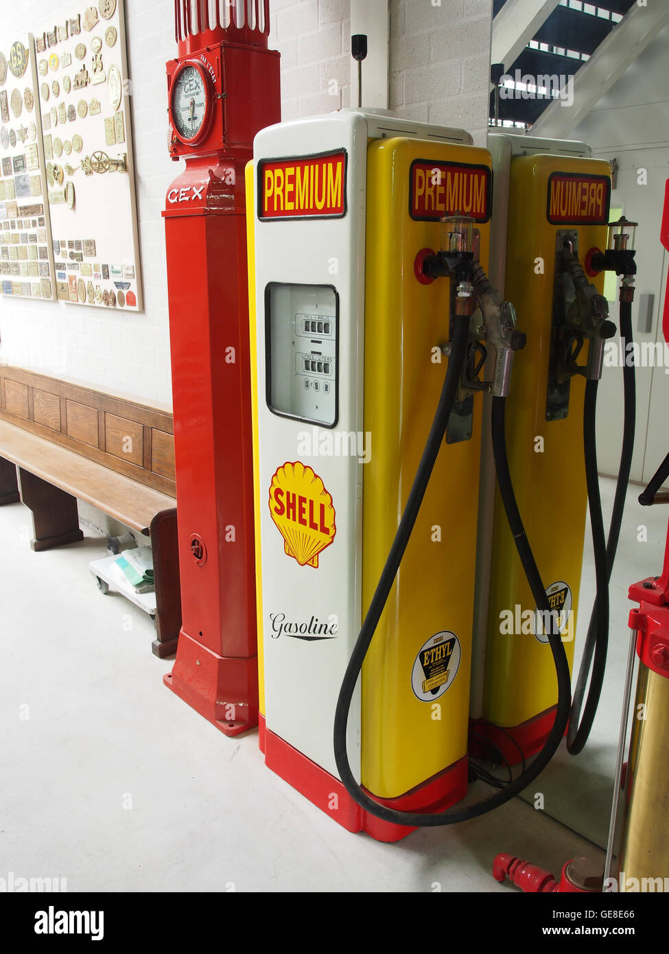 This image features a vintage Shell Premium gasoline pump displayed in ...