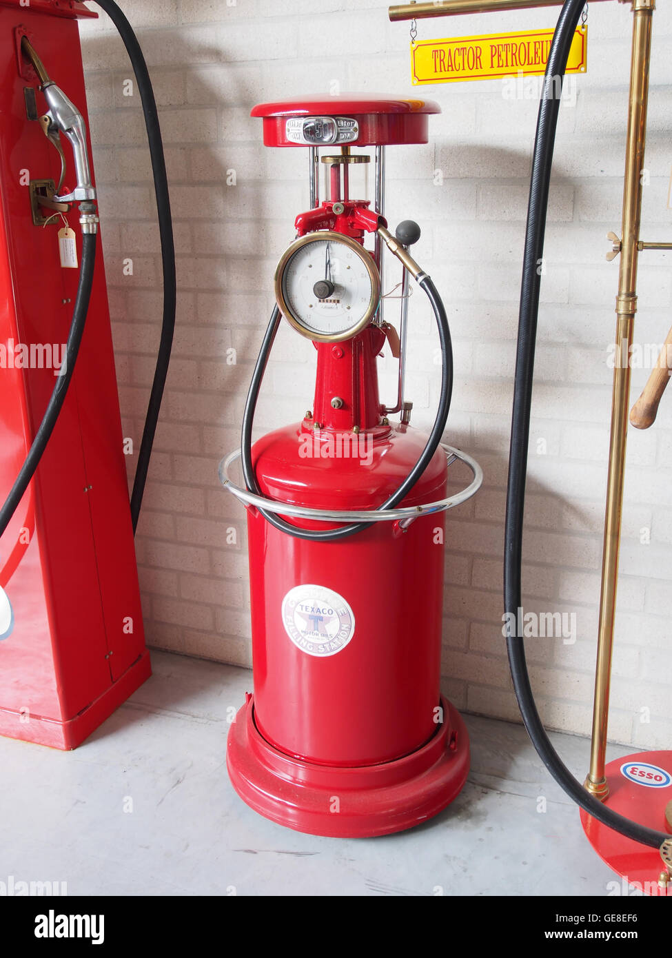 This historical photograph shows a Texaco gasoline filling station. The ...
