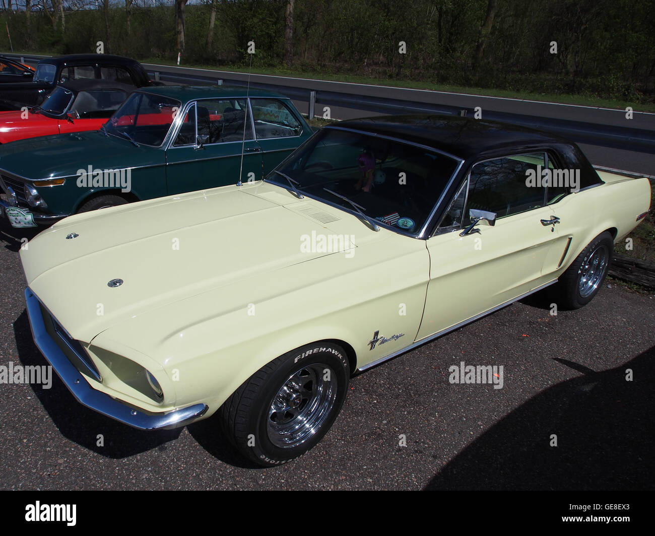 This image features a yellow 1968 Ford Mustang, a classic American ...