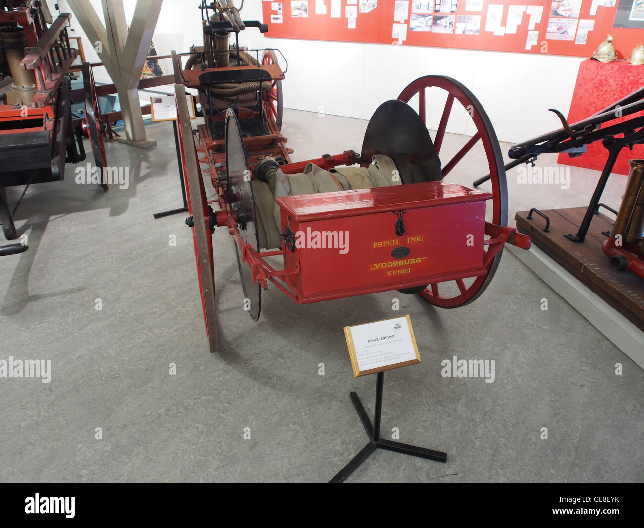 This image shows a historic hand-pump fire engine manufactured by A ...