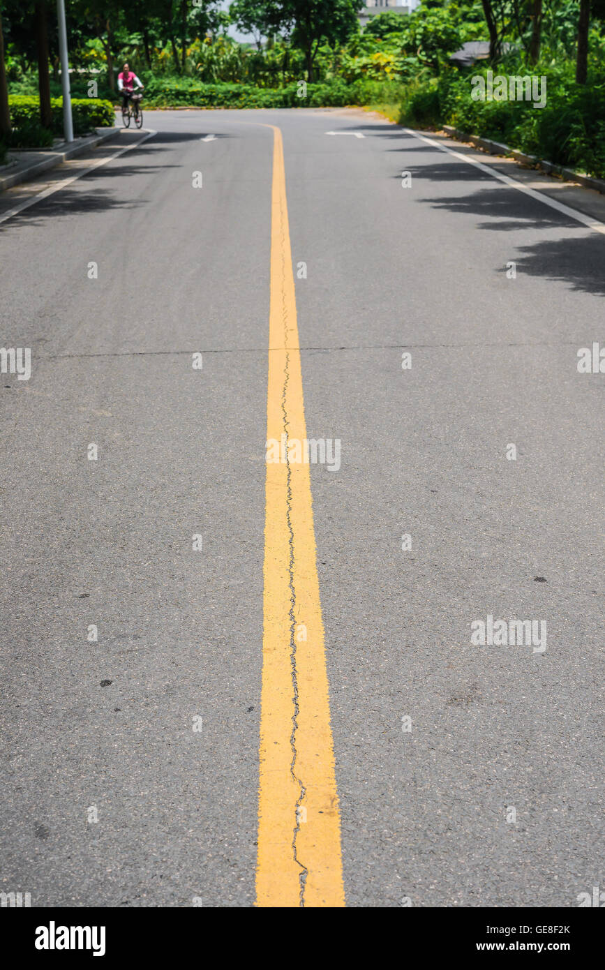 blacktop with double yellow lines divider under sunshine, an ...