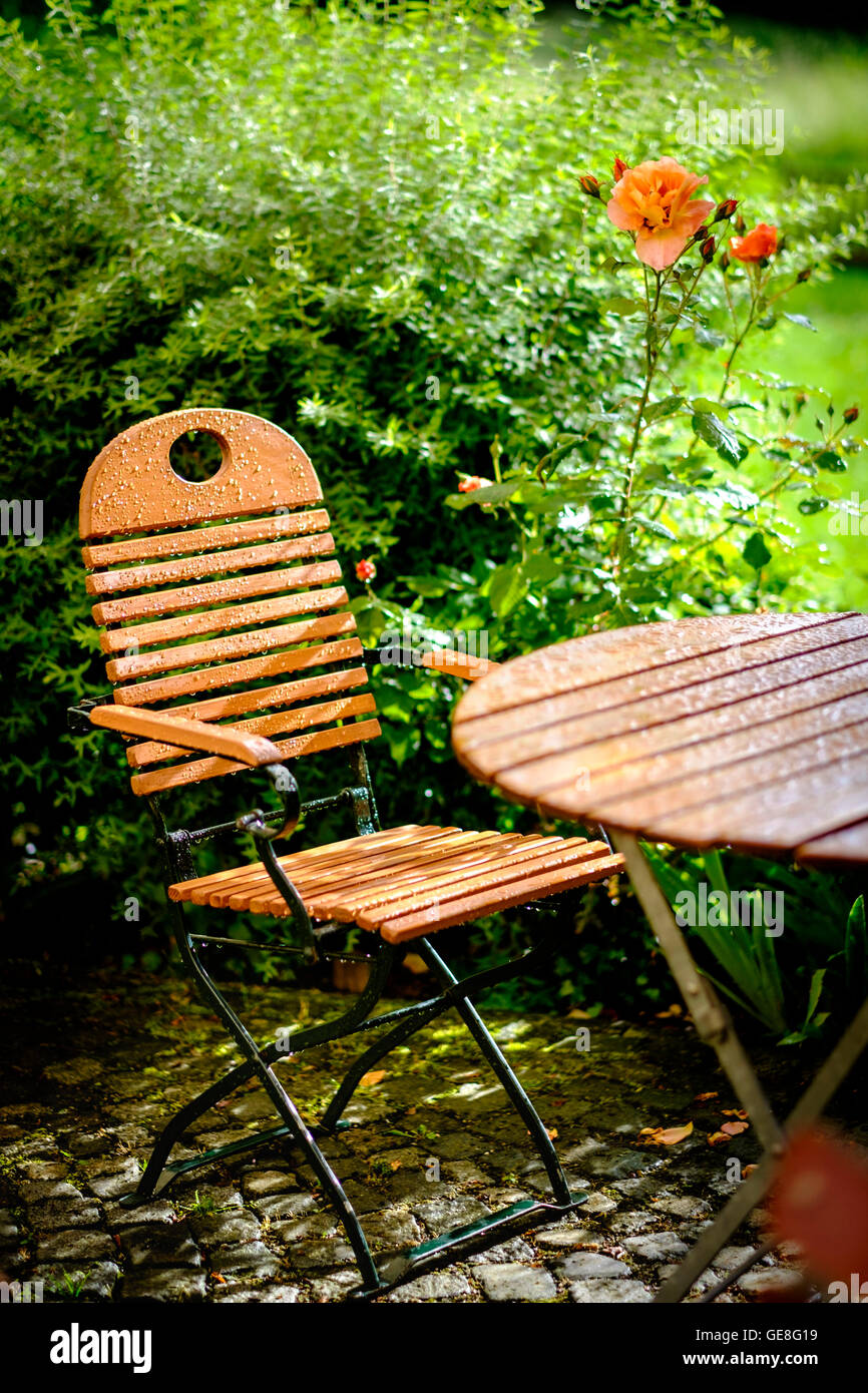 Garden table and chair, summer rain Stock Photo - Alamy
