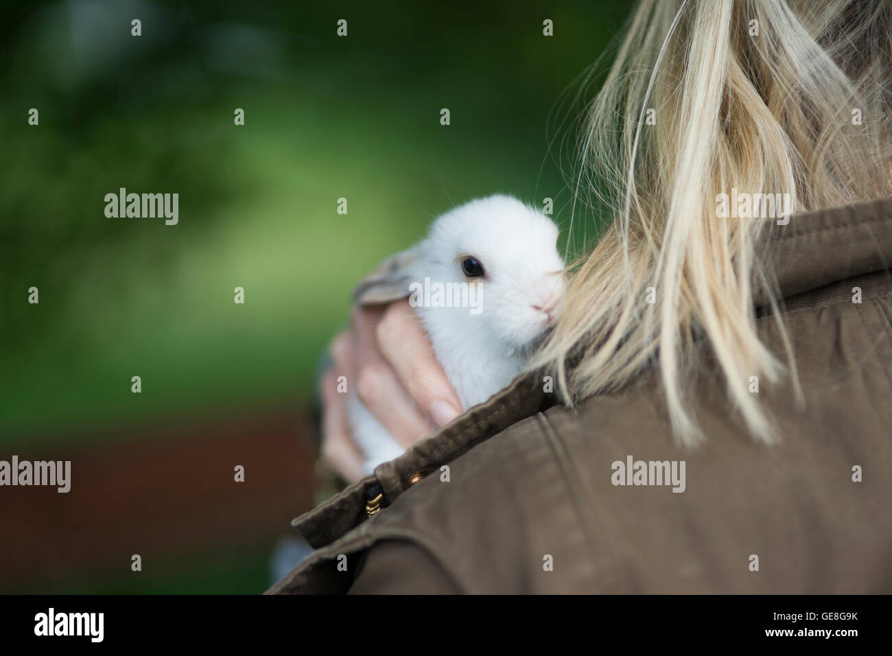 Little hare on shoulder of blonde woman Stock Photo - Alamy
