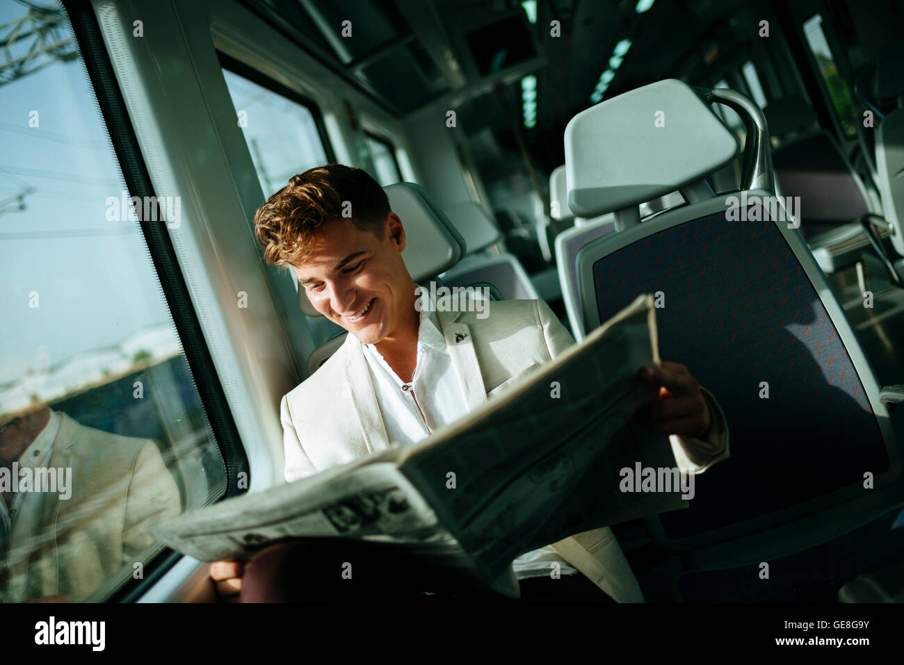 Reading newspaper on train hi-res stock photography and images - Alamy