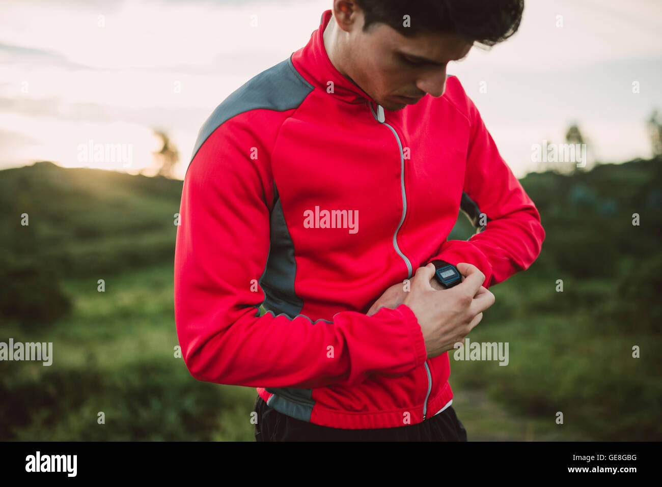 Trail runner man looking at his watch ready to start training Stock ...