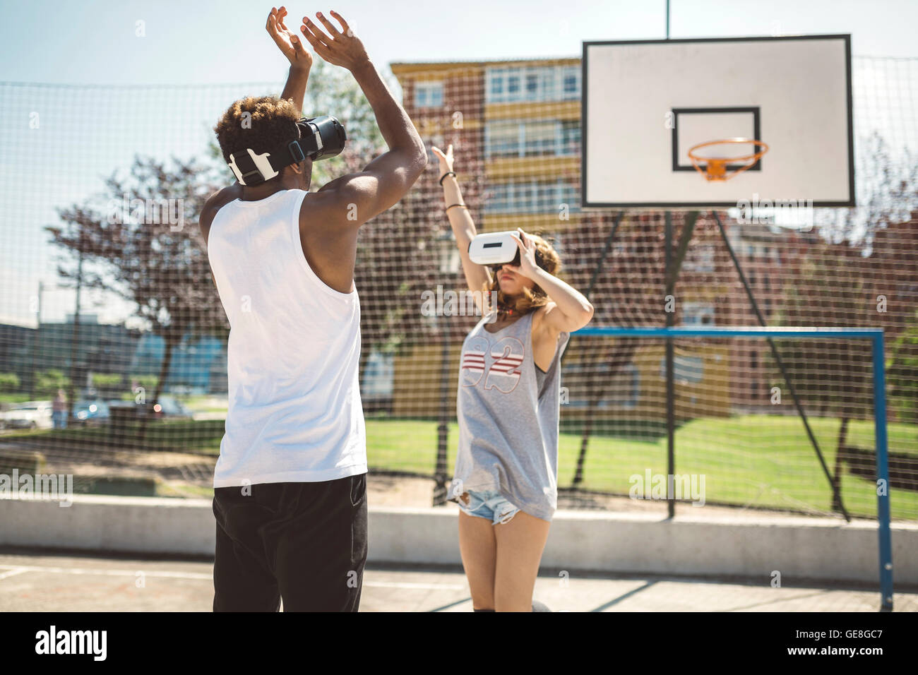 Young couple playing basketball with virtual reality glasses on Stock ...