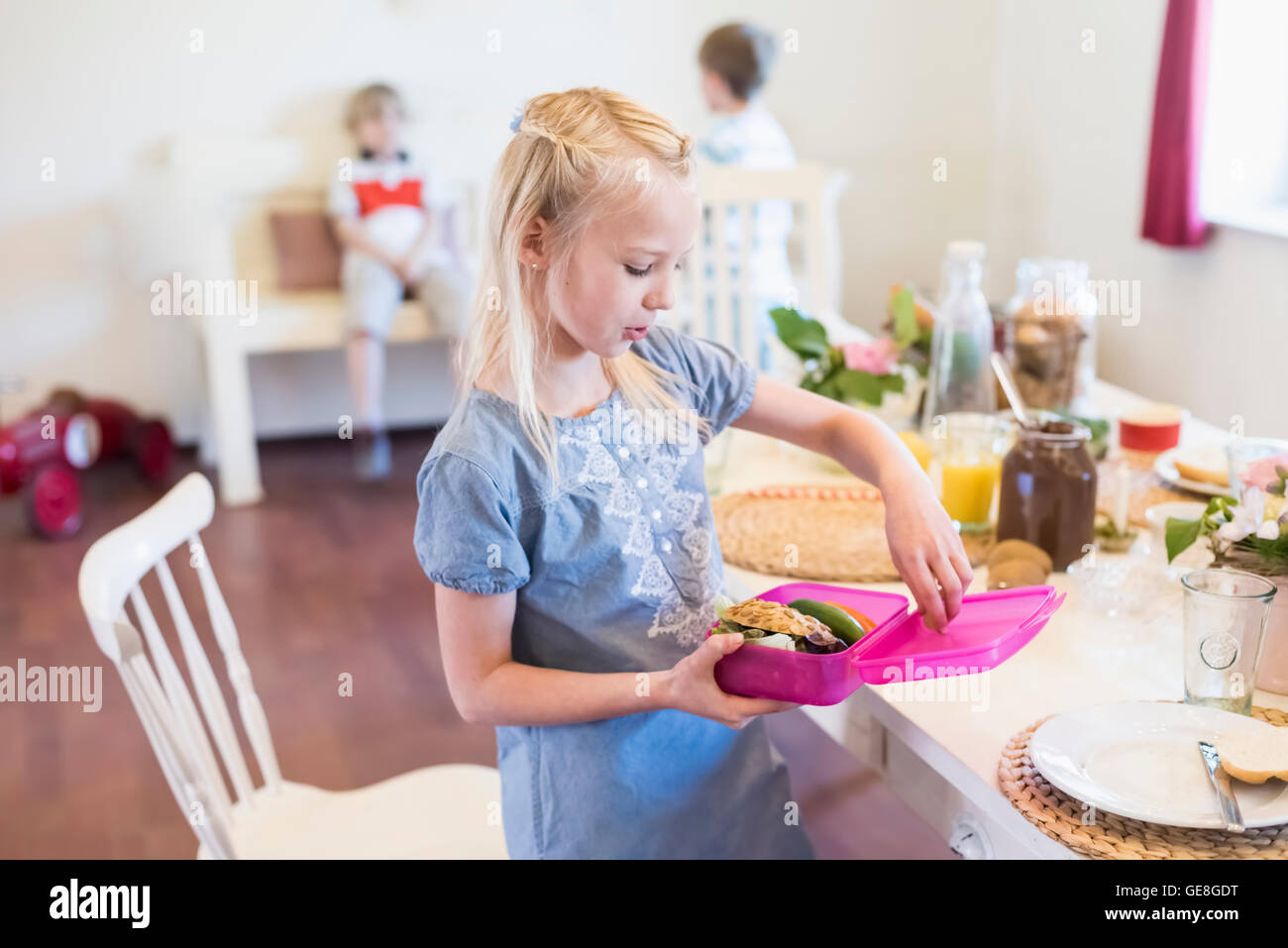 Girl packing lunch box Stock Photo - Alamy