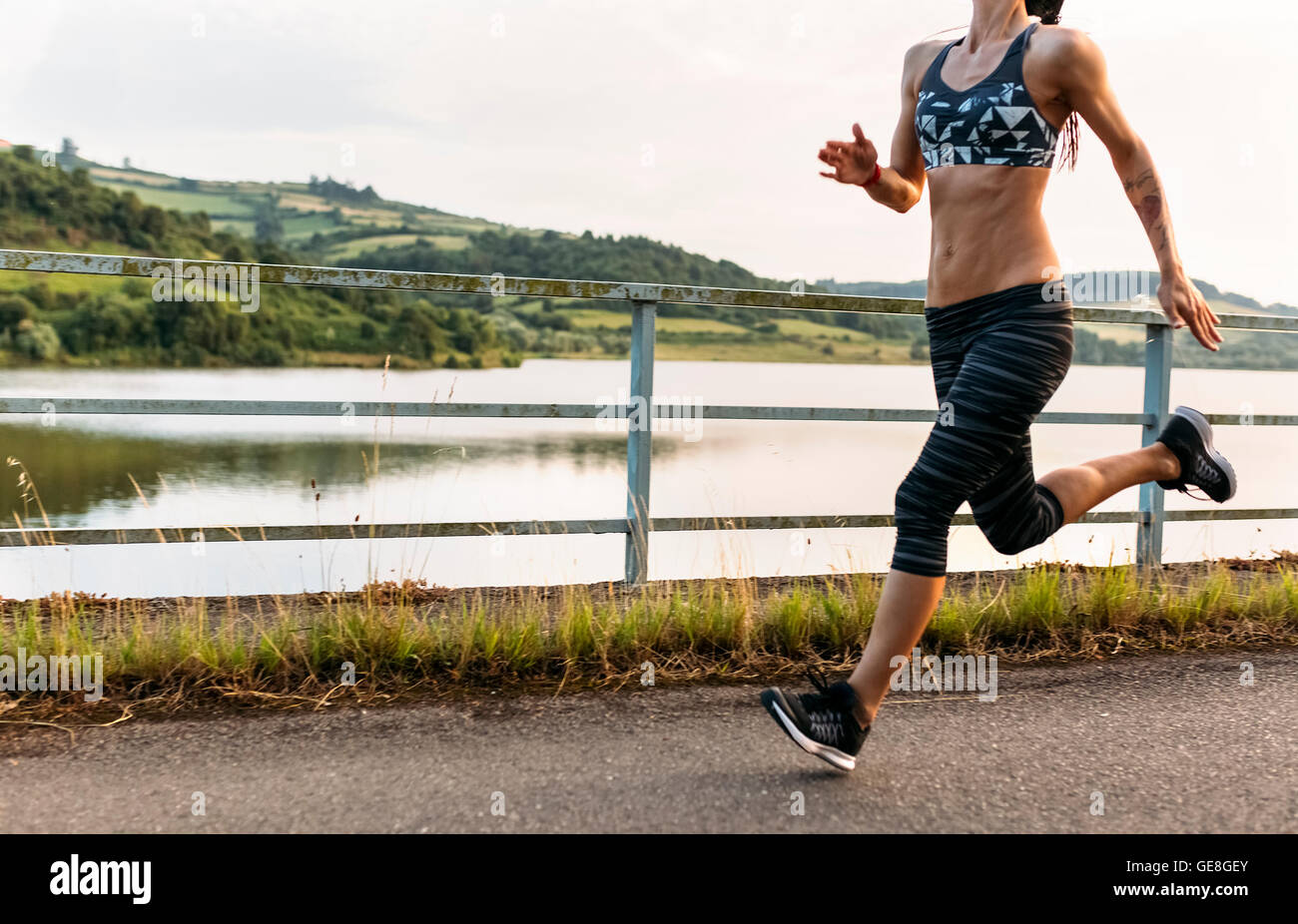 Woman running outdoors Stock Photo - Alamy
