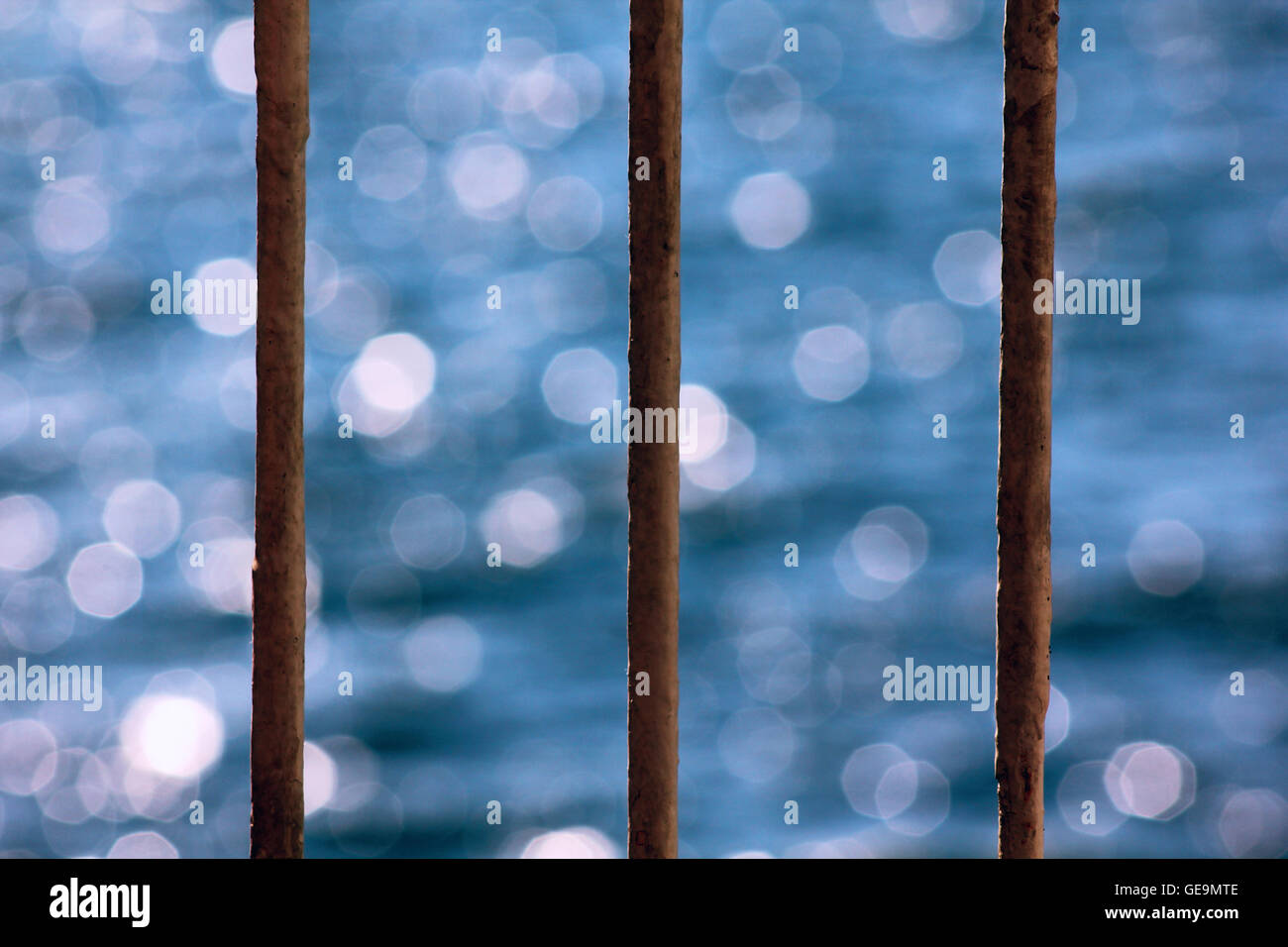 The blue sea behind the rusty bars Stock Photo - Alamy