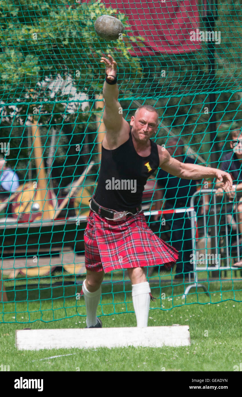 A participant of the Highland Games throws a hammer from the throwing ...
