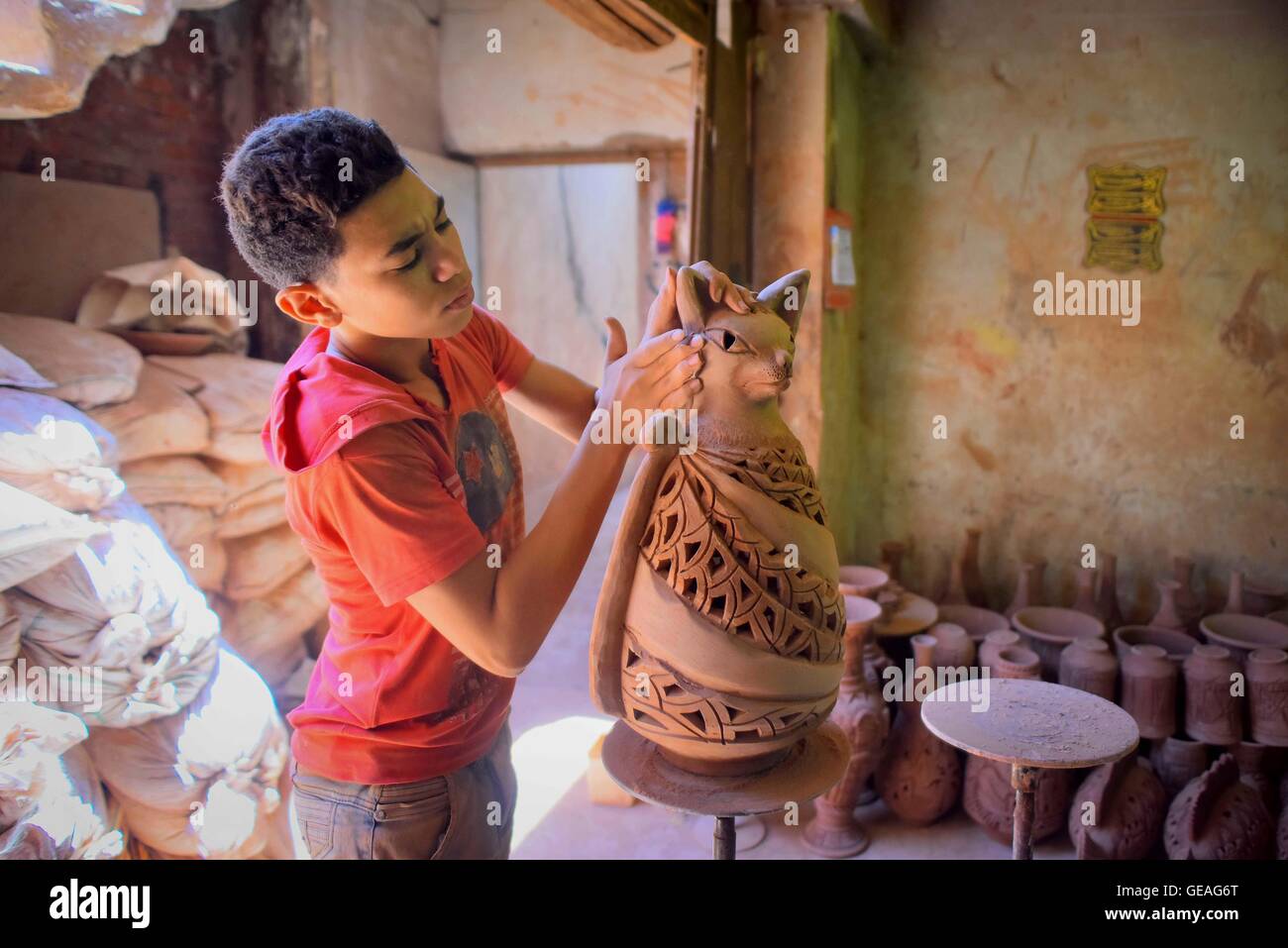 Cairo, Egypt. 24th July, 2016. An Egyptian boy works at a pottery ...