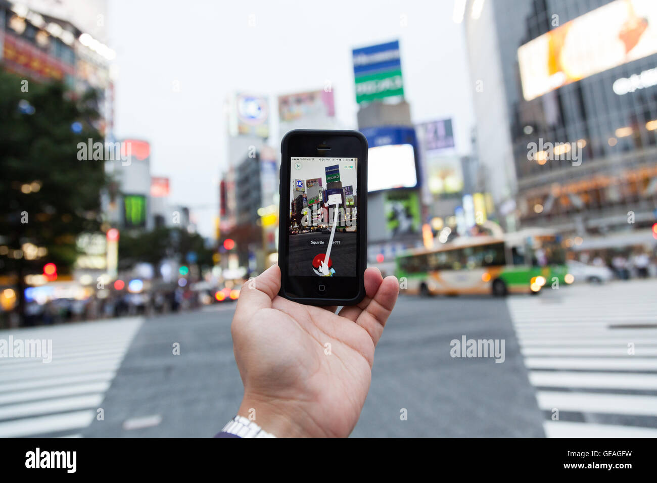 A fan tries out Pokemon Go in Tokyo's Shibuya district on July 22, 2016 ...