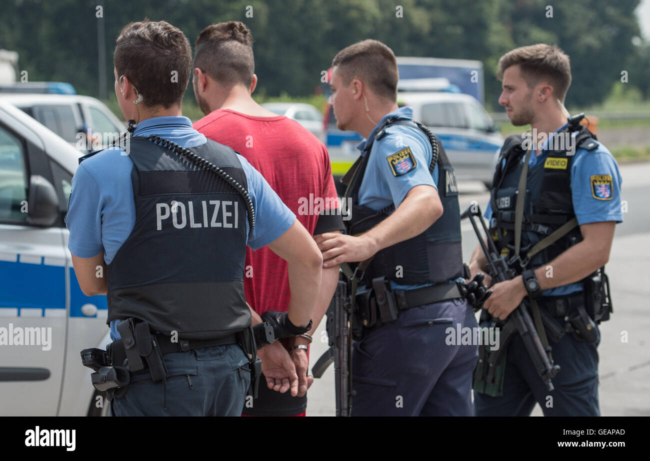 Medenbach, Germany. 25th July, 2016. Police officers have handcuffed a ...