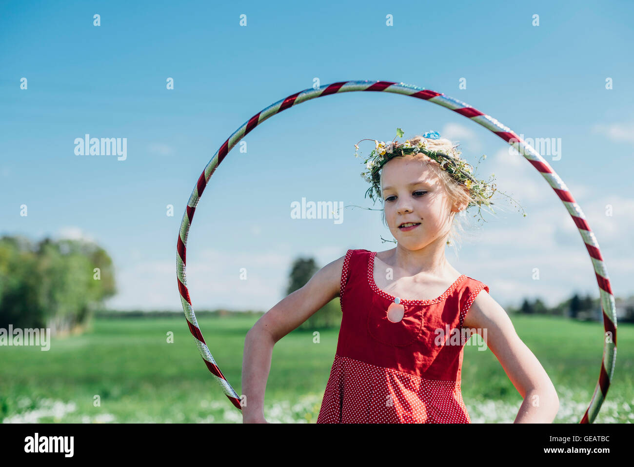Girl with hula hoop wearing flower wreath Stock Photo - Alamy