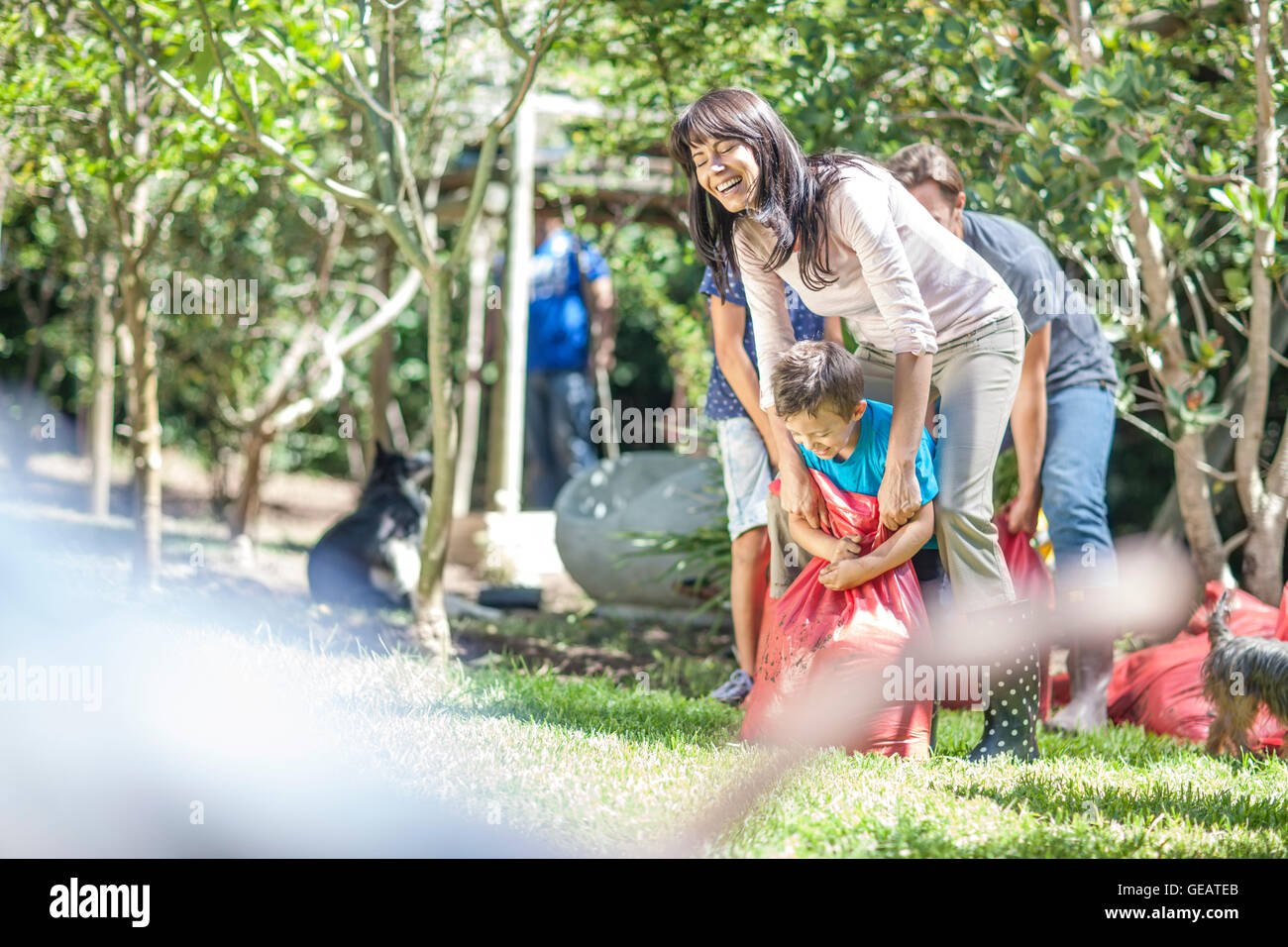 Family having fun in garden Stock Photo - Alamy