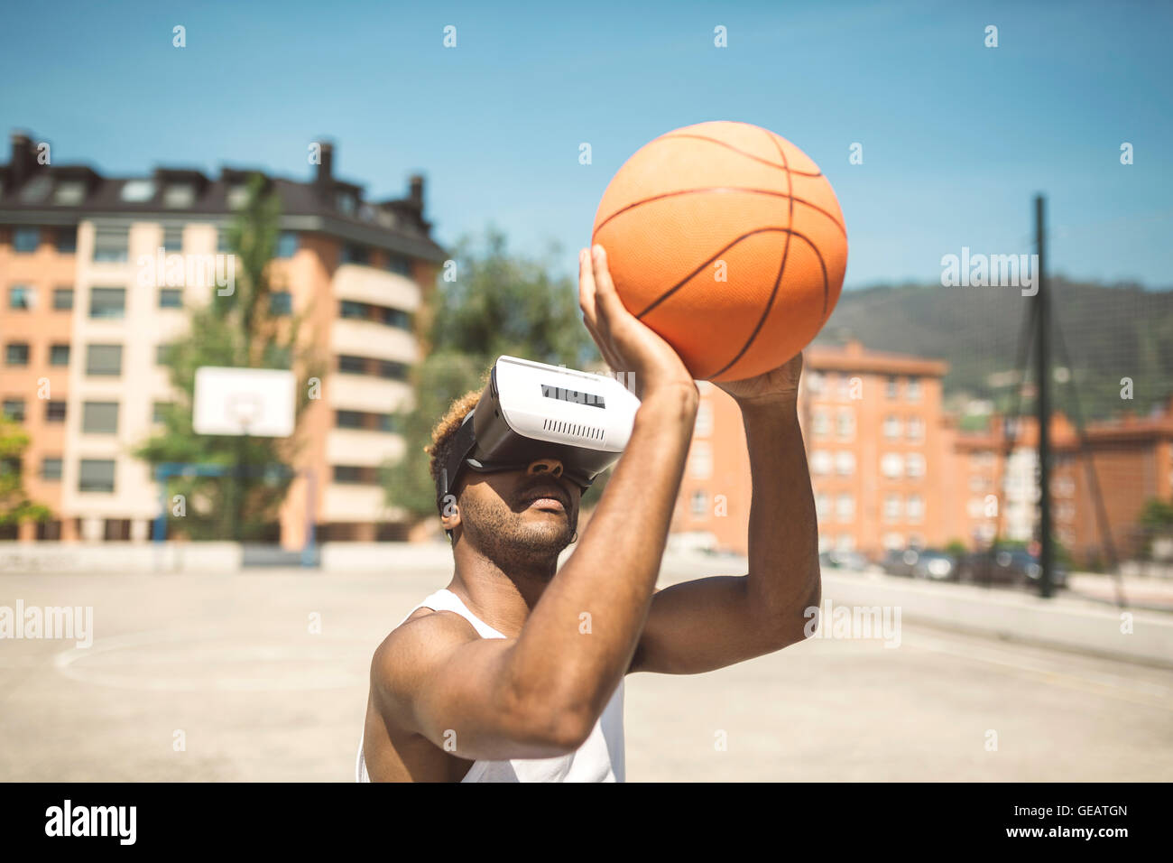 Young man playing basketball with virtual reality glasses on Stock ...