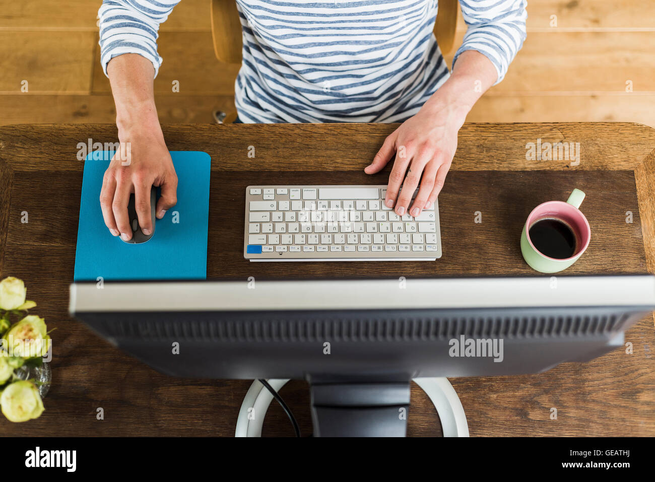 Man using computer at desk Stock Photo - Alamy