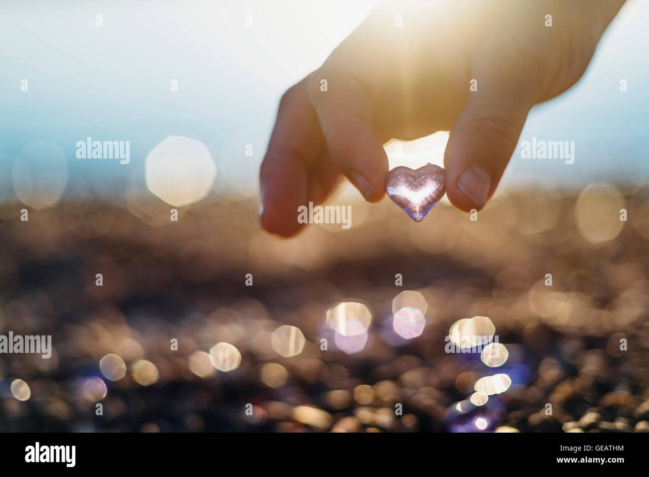 Man holding glass heart in hand Stock Photo - Alamy