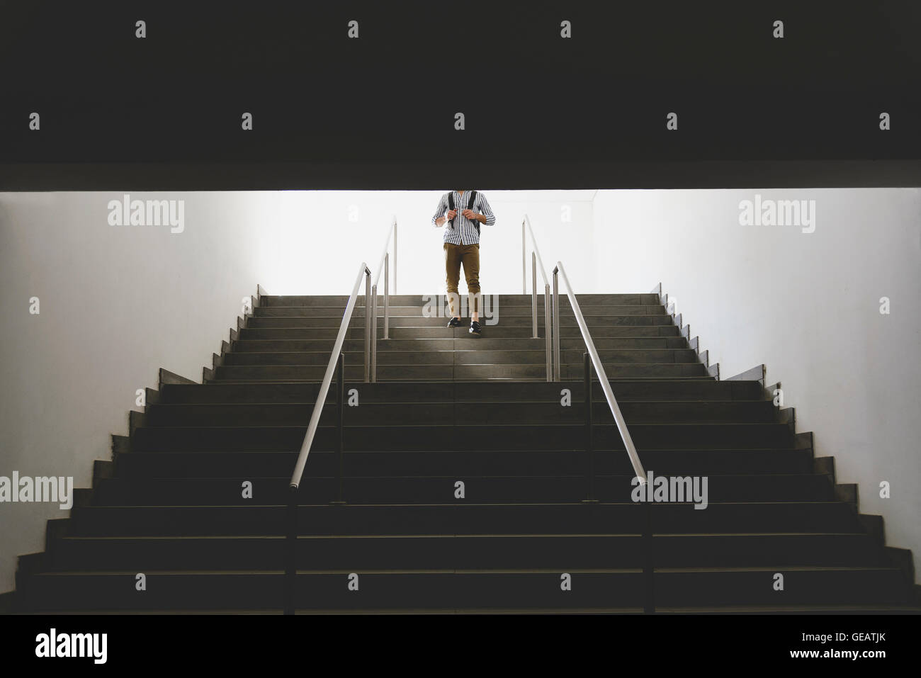 Man walking downstairs hi-res stock photography and images - Alamy