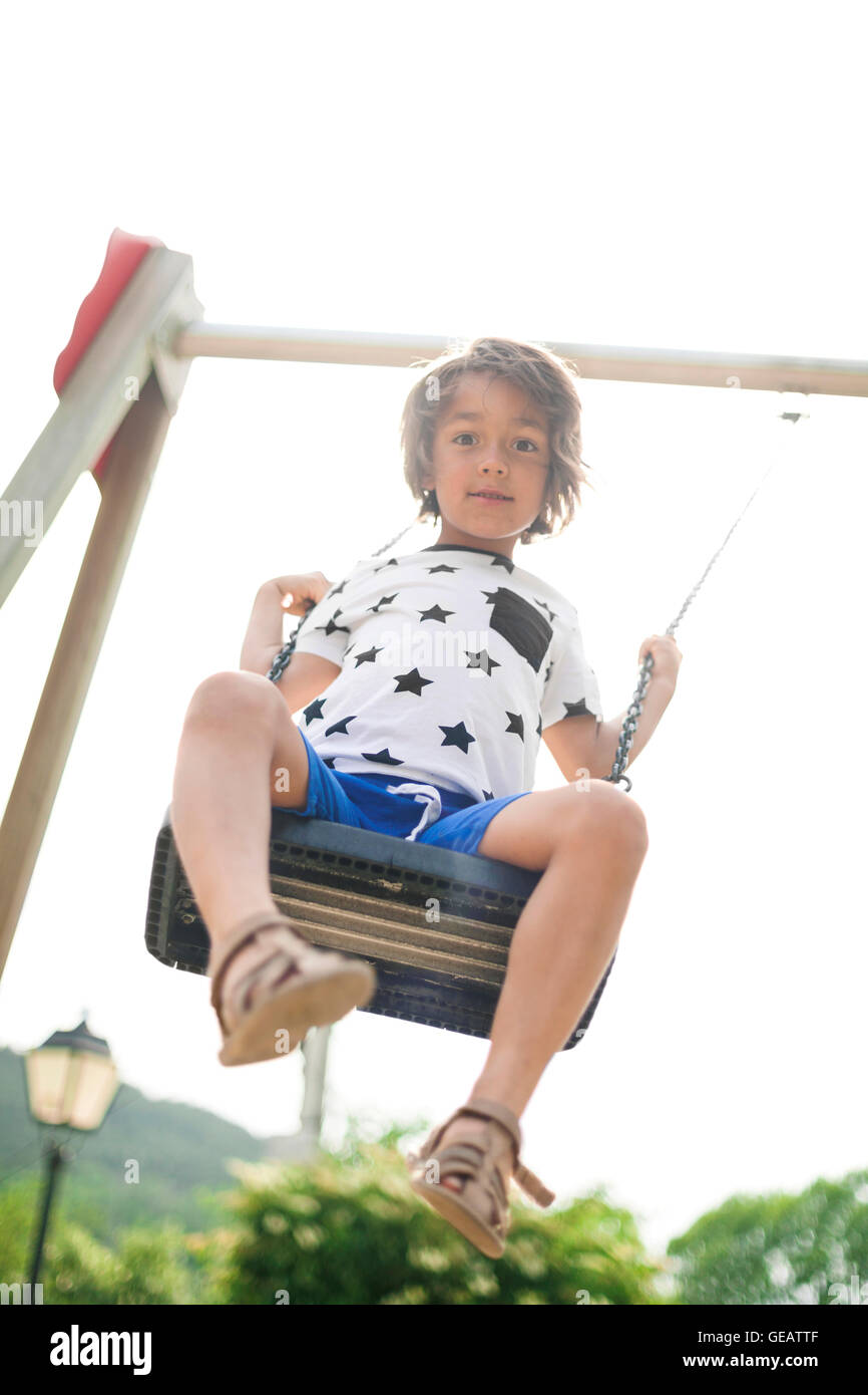 Portrait of little boy on a swing Stock Photo - Alamy