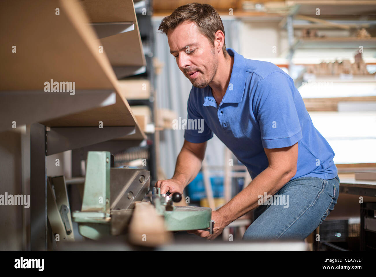 Man working on clamp tool in workshop Stock Photo - Alamy